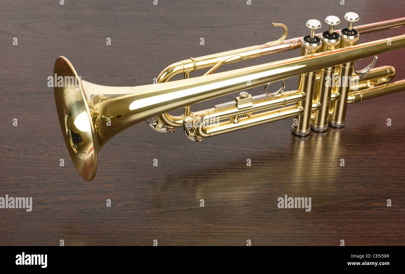 trumpet closeup on brown wooden background Stock Photo - Alamy