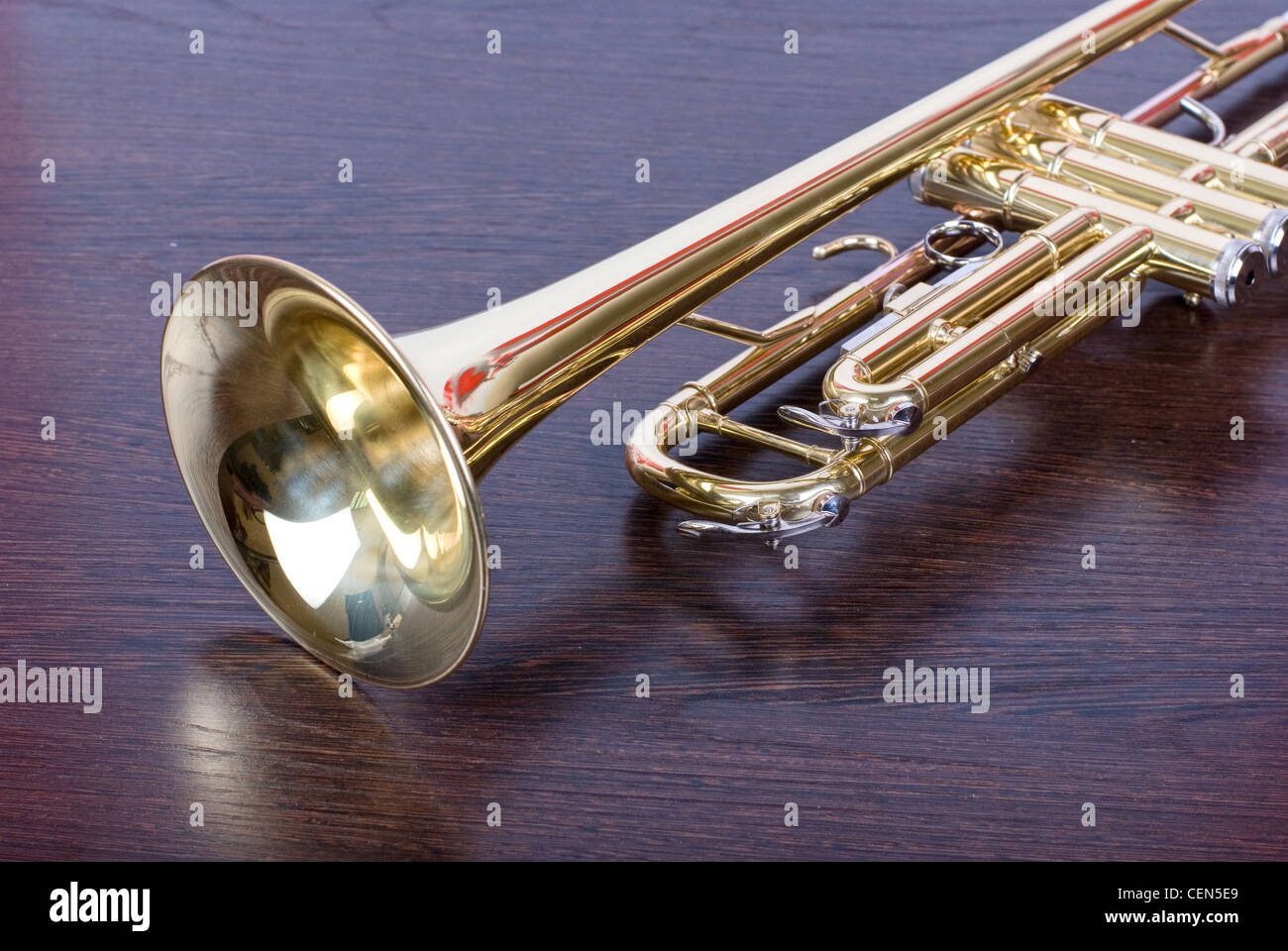 trumpet closeup on brown wooden background Stock Photo - Alamy