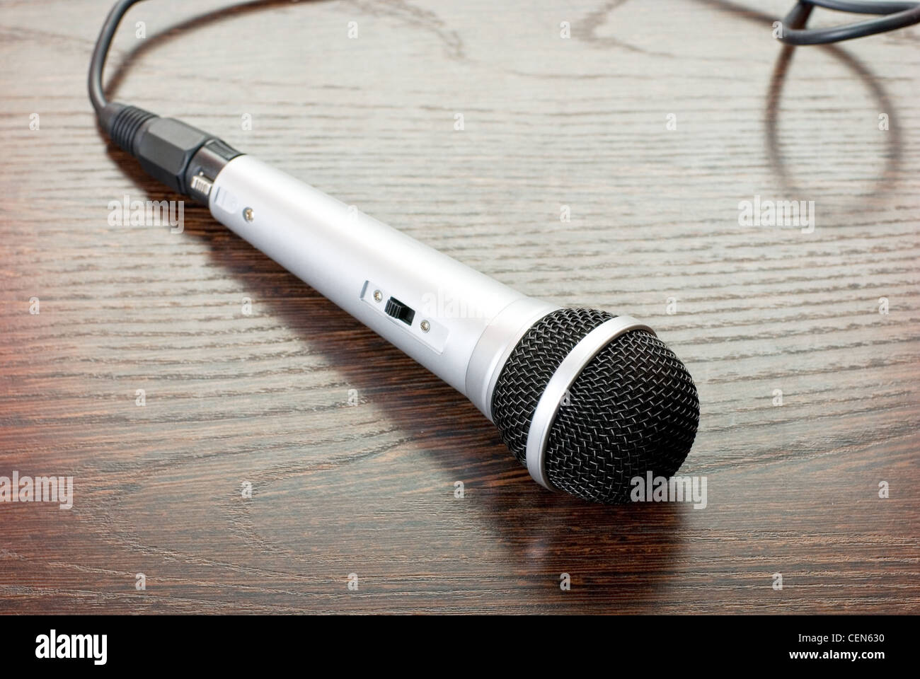 The microphone on a brown wooden background Stock Photo - Alamy