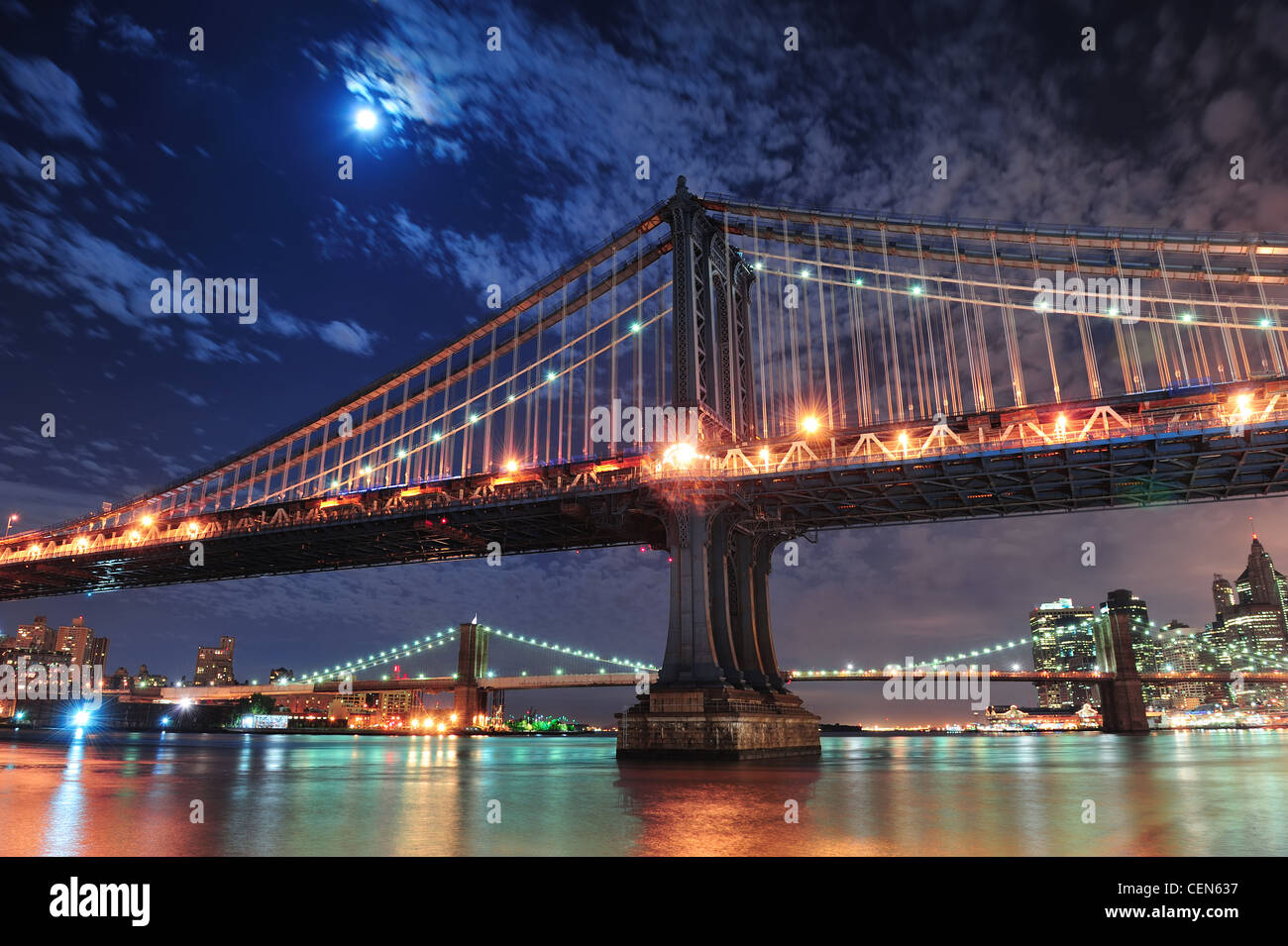 Brooklyn Bridge and Manhattan Bridge over East River at night with moon ...