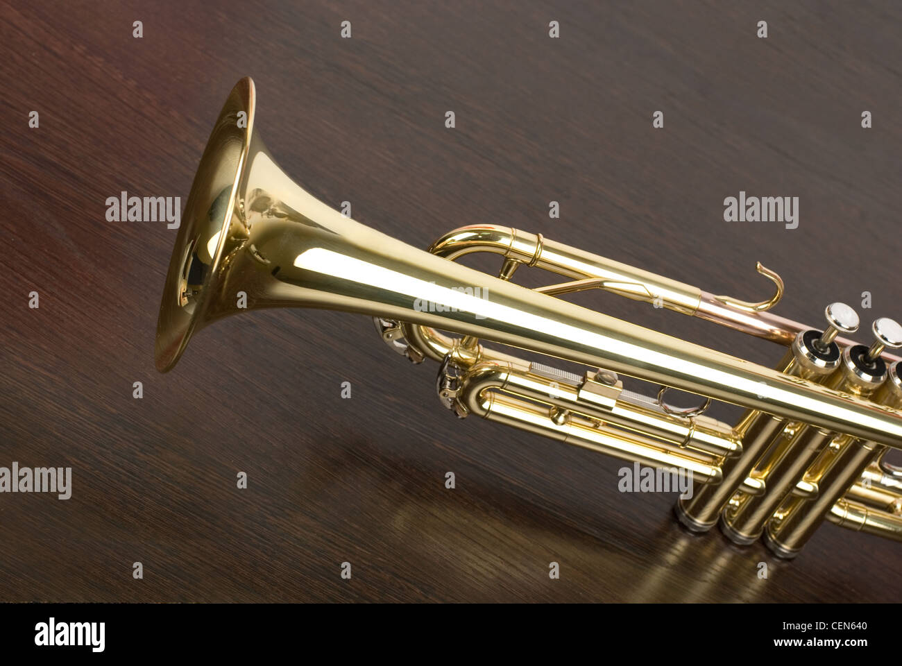 trumpet closeup on brown wooden background Stock Photo - Alamy
