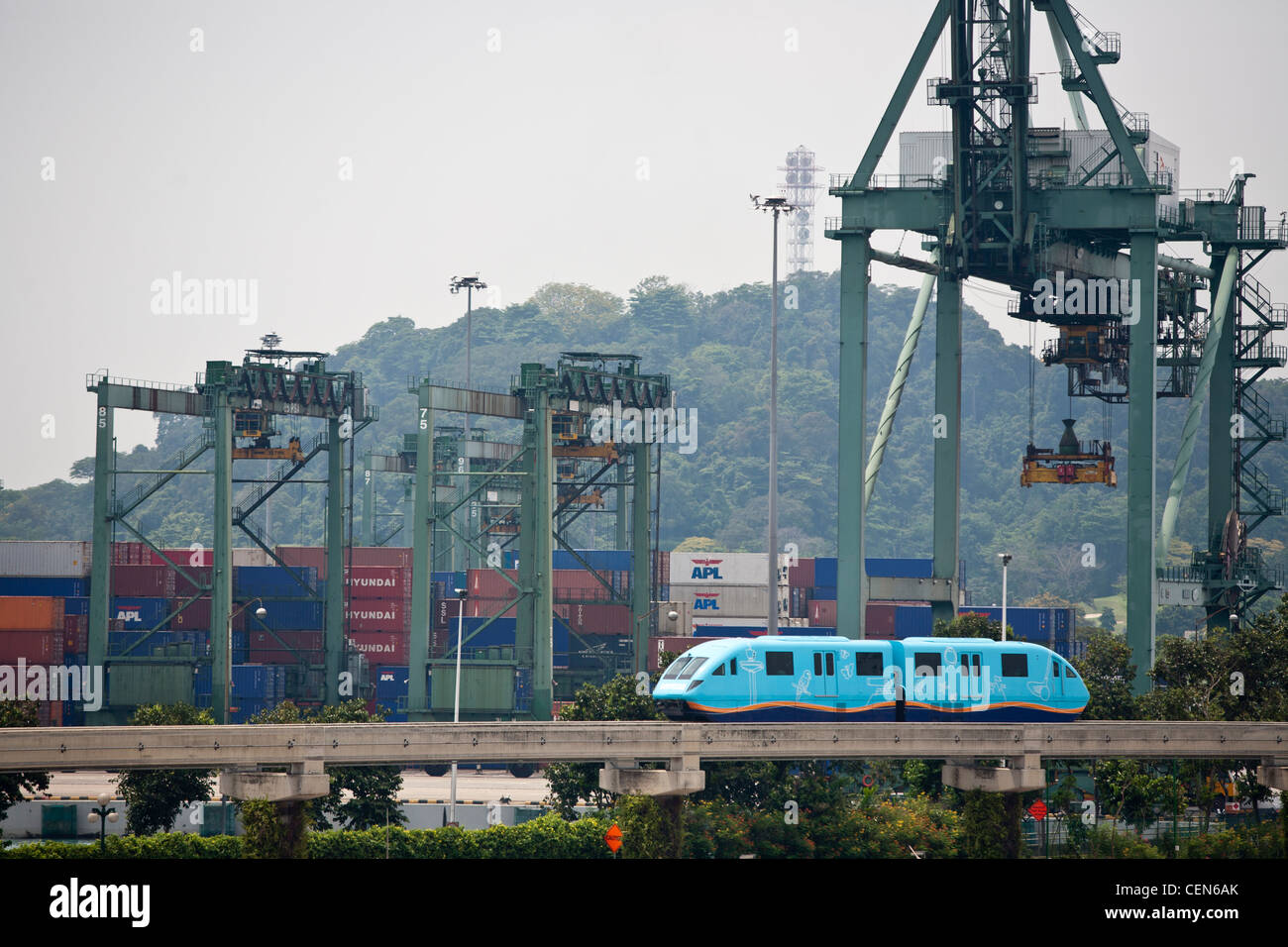 A Sentosa Express monorail passes in front of cargo containers at the ...