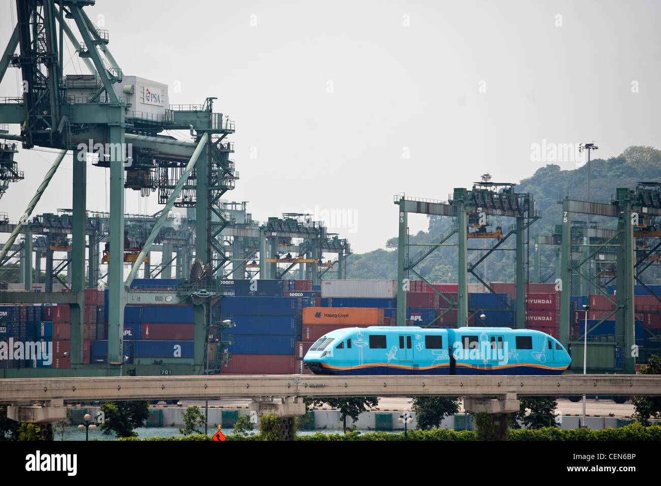 A Sentosa Express monorail passes in front of cargo containers at the ...