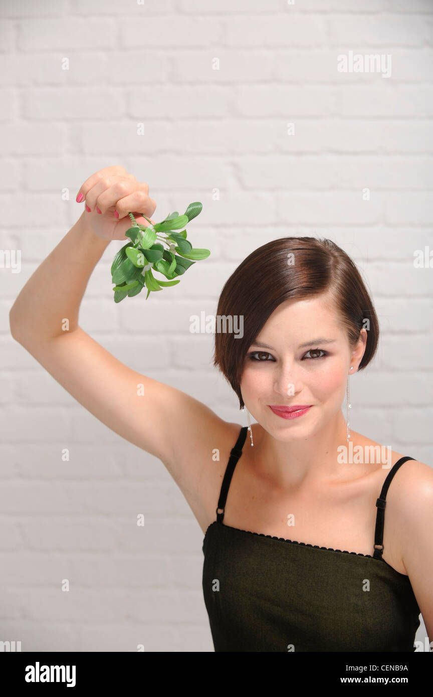 Female short brunette hair, wearing a black dress and silver drop ...