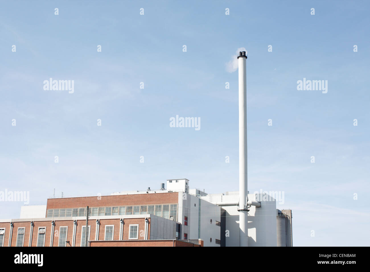 A factory with a tall chimney Stock Photo - Alamy