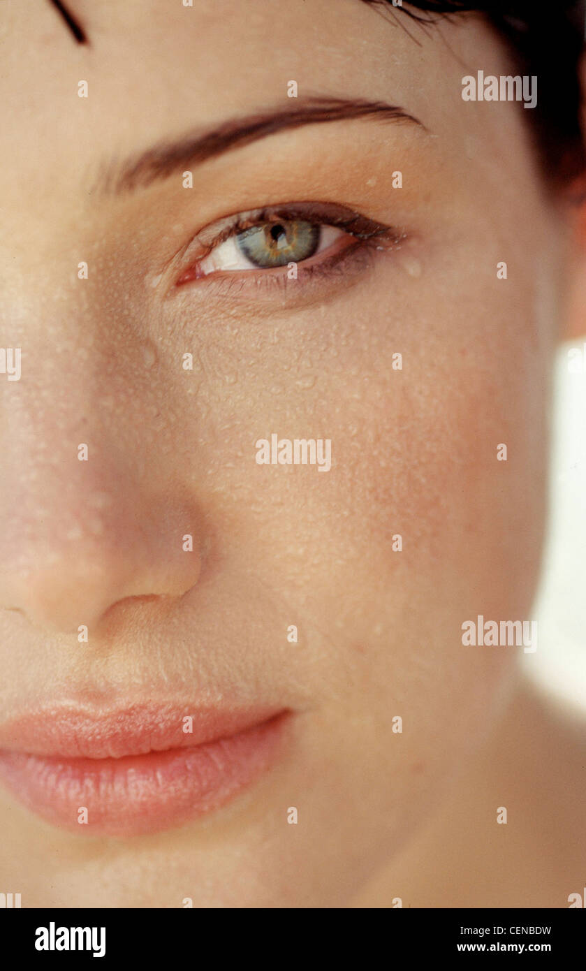 Cropped female with wet black hair and short fringe wearing lipgloss ...