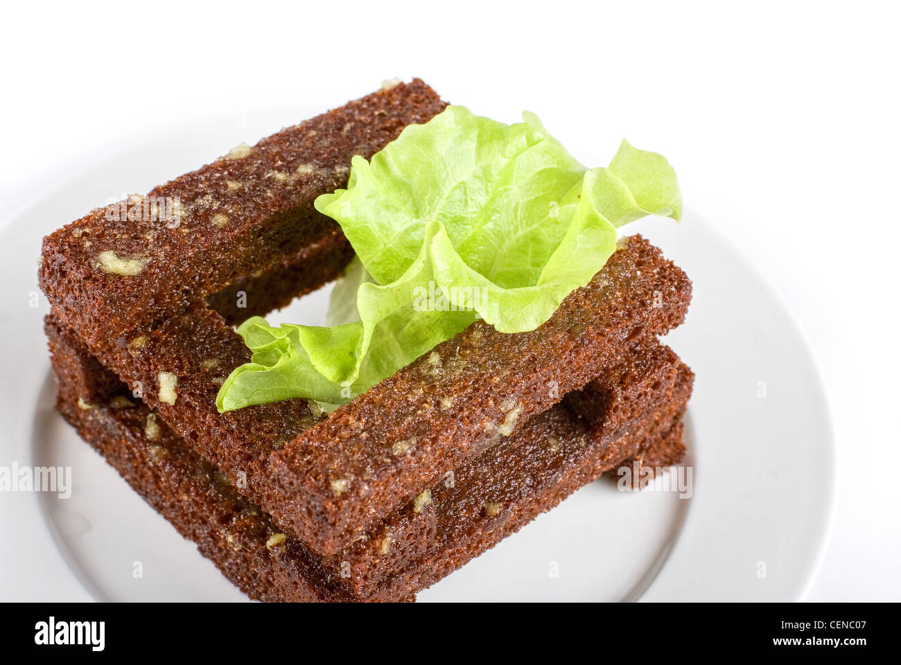 toasted bread closeup with garlic at lettuce leaf on white Stock Photo ...