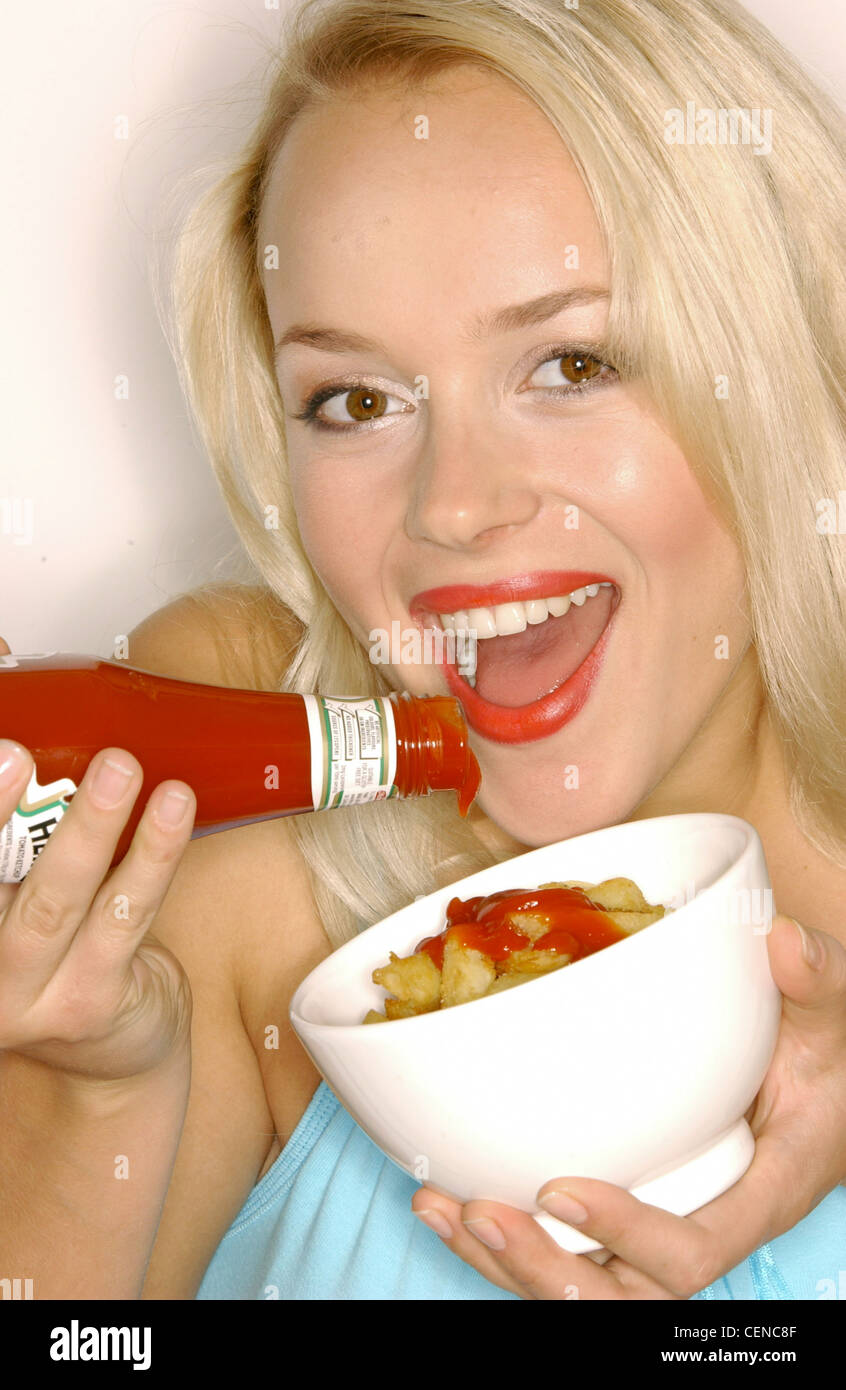 Female Long Blonde Hair Wearing Light Blue Vest Top And Red Lipstick