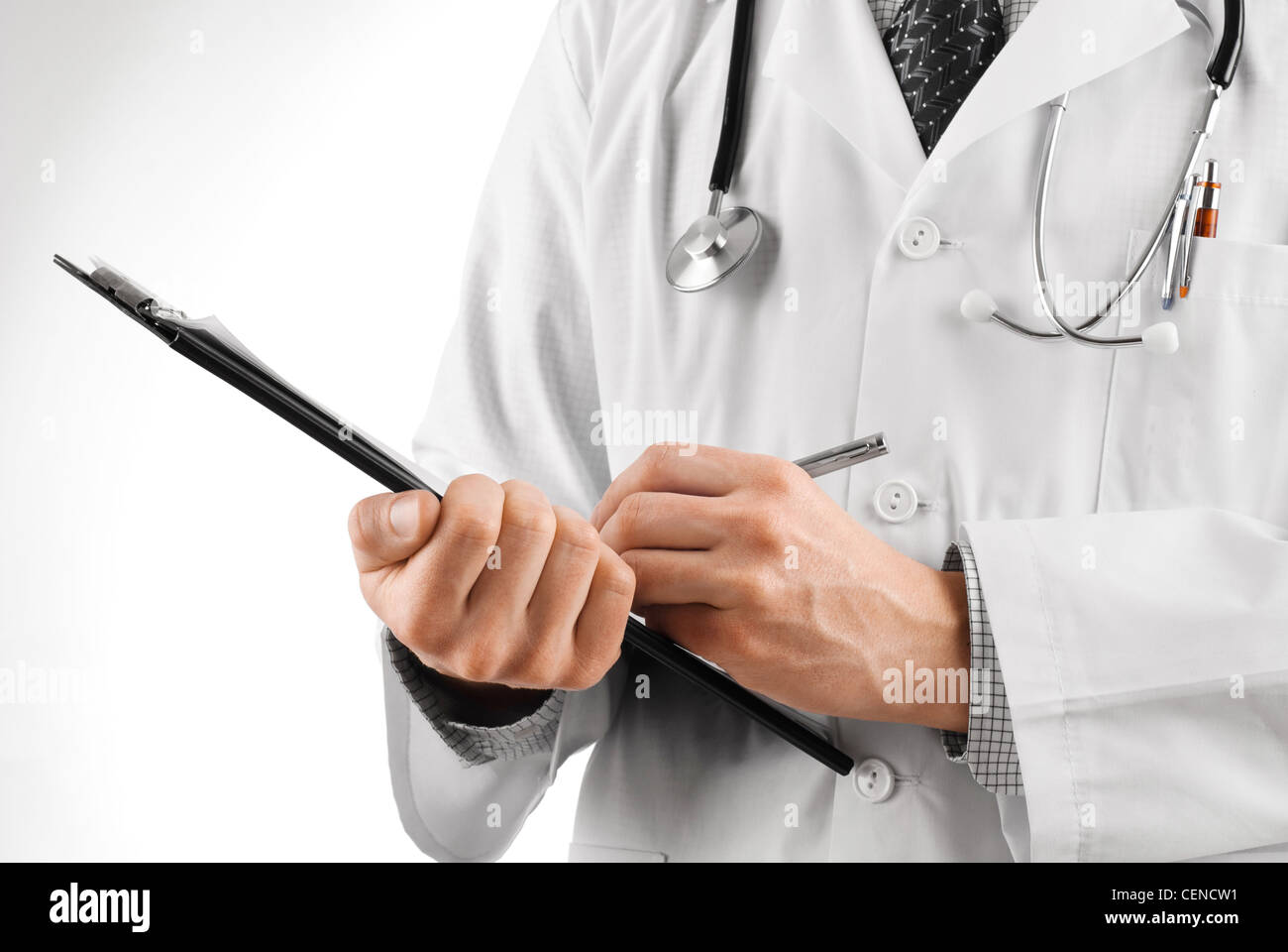 Doctor writing something on clip board Stock Photo - Alamy