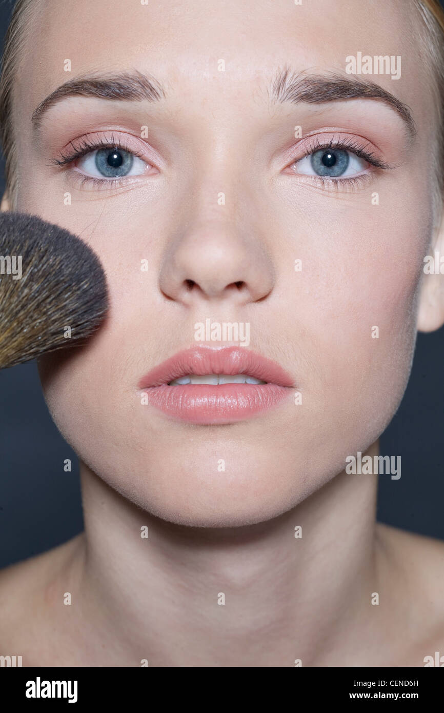 Step by Step Beauty and Make Up Female applying blusher to her cheek ...