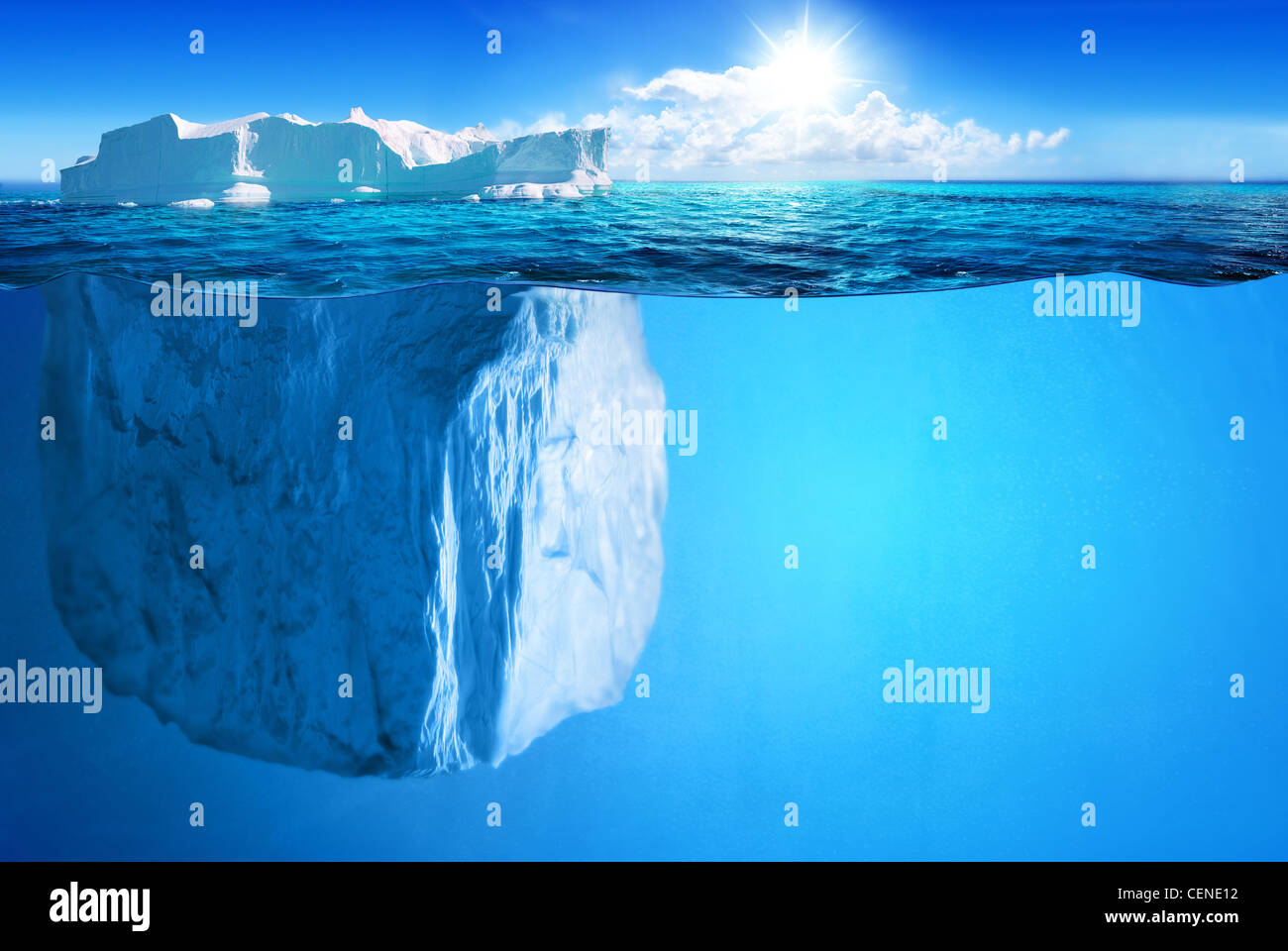 Iceberg coming out of water shot with sun on background Stock Photo - Alamy