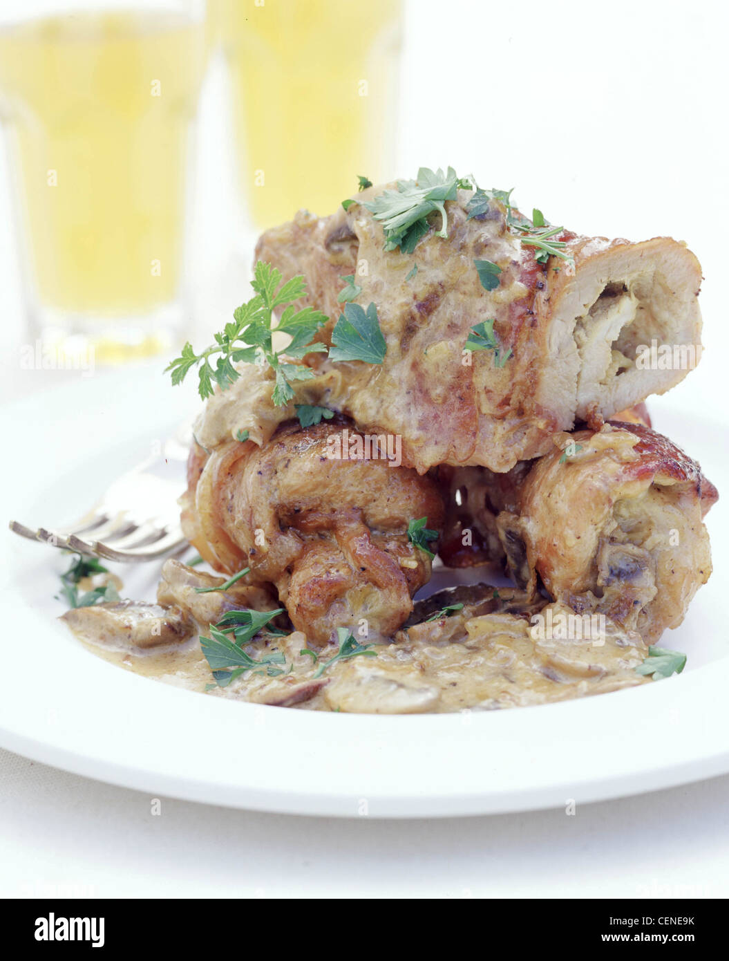 Pork pockets with creamy mushroom sauce sprinkled with chopped fresh ...