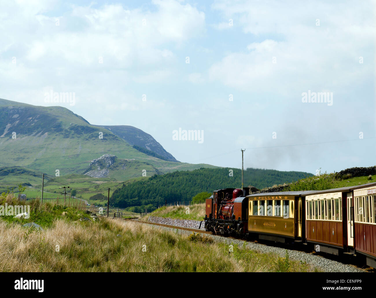 welsh highland railway train with mountains in distance pont croesor near porthmadog gwynedd ...
