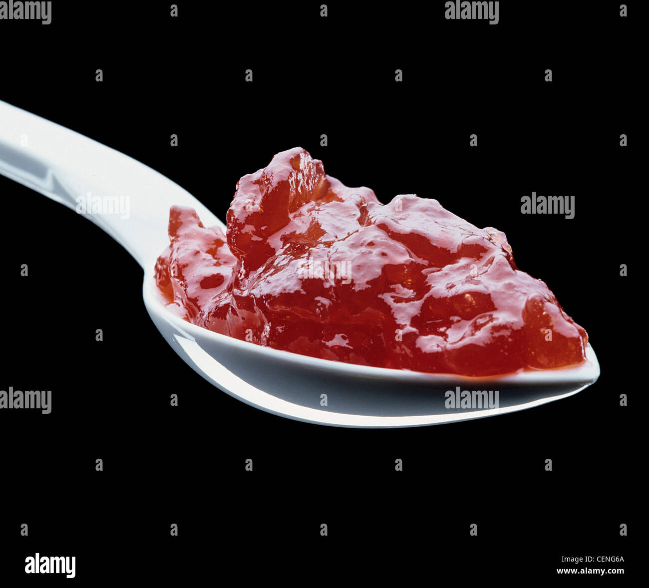 Still life image of a spoon of red jam Stock Photo - Alamy