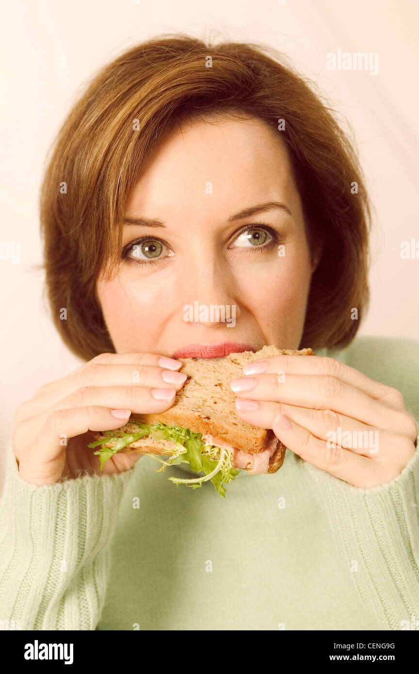 Female with shoulder length brunette hair wearing green roll neck ...
