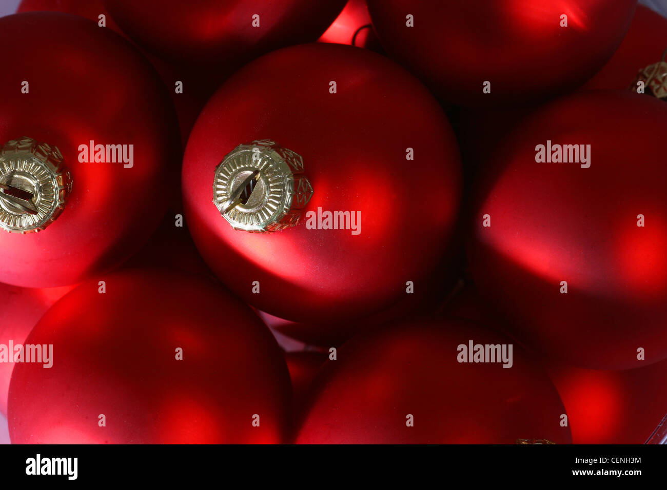 A close up of metallic red baubles, on a reflective surface Stock Photo ...