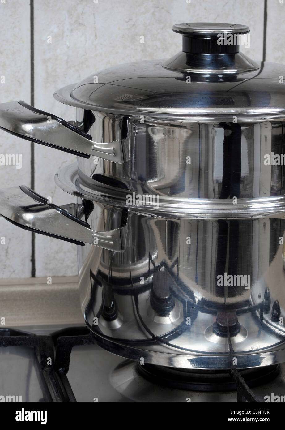 A double tiered steamer on a gas hob Stock Photo - Alamy