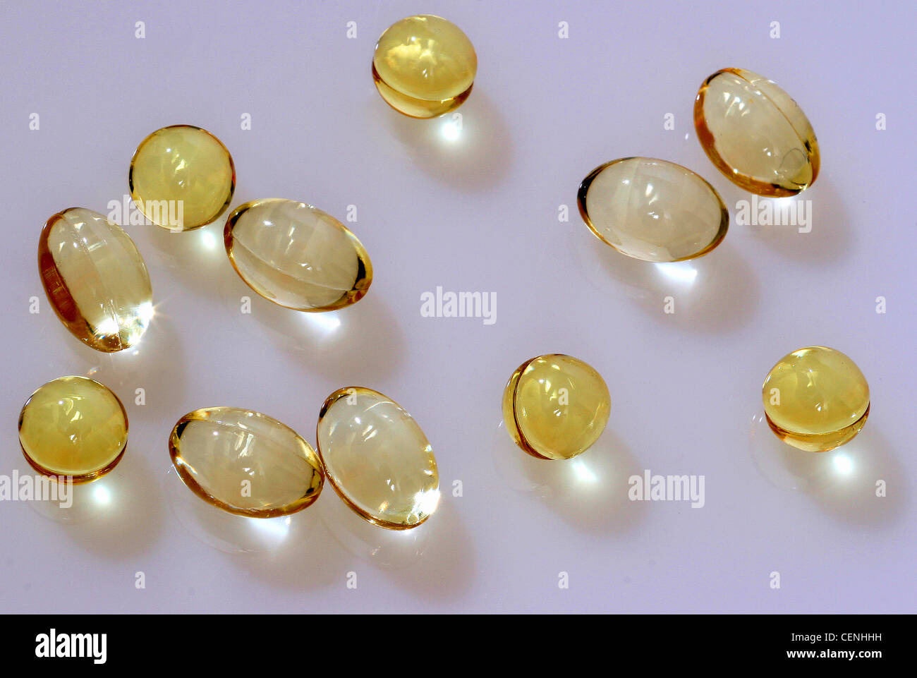 Yellow liquid capsules of different shapes Stock Photo - Alamy