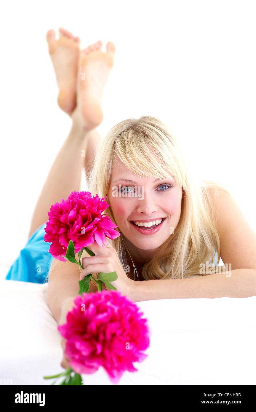 Female long straight blonde hair wearing blue dress lying forward on ...
