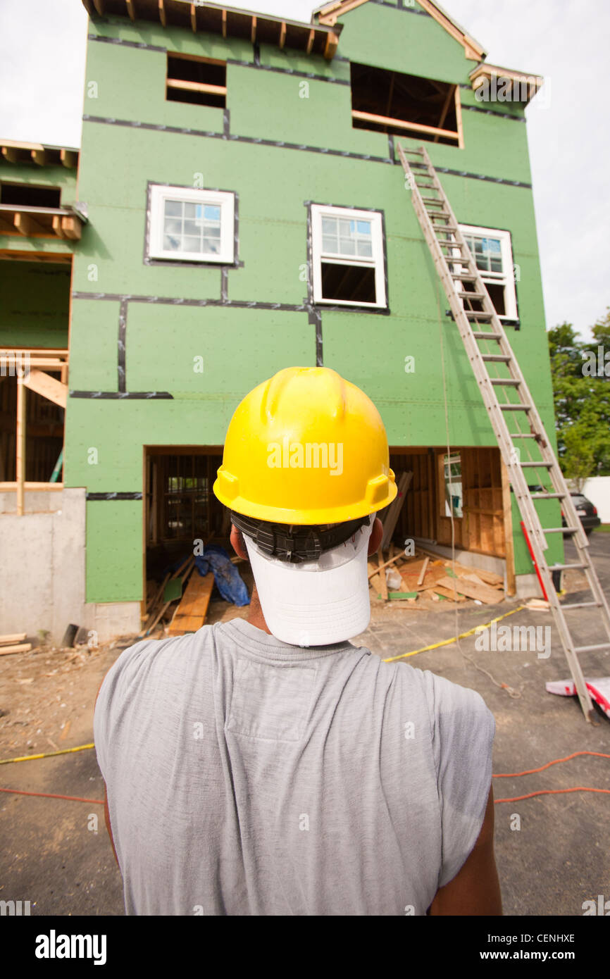Hispanic carpenter observing new window installation Stock Photo - Alamy