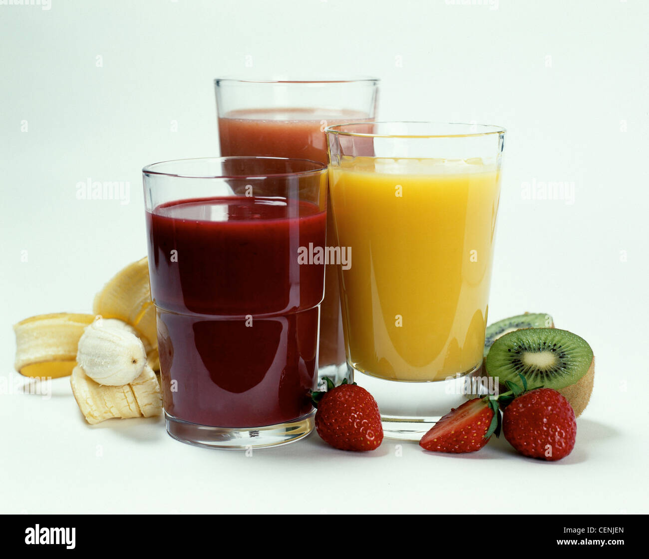 Still life of three glasses of fruit smoothies, on a white background ...