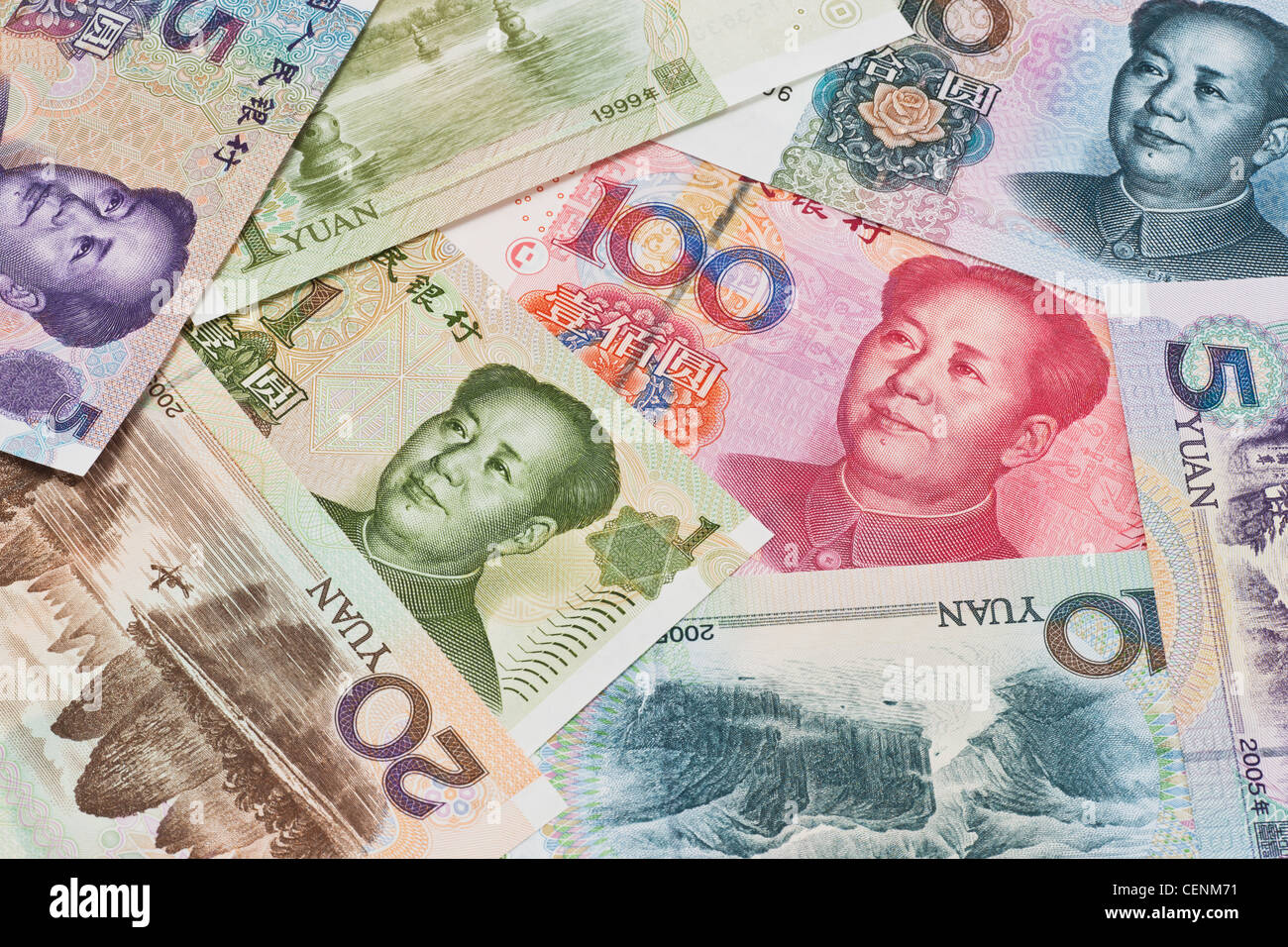 Many Yuan bills with the portrait of Mao Zedong lying side by side. The ...