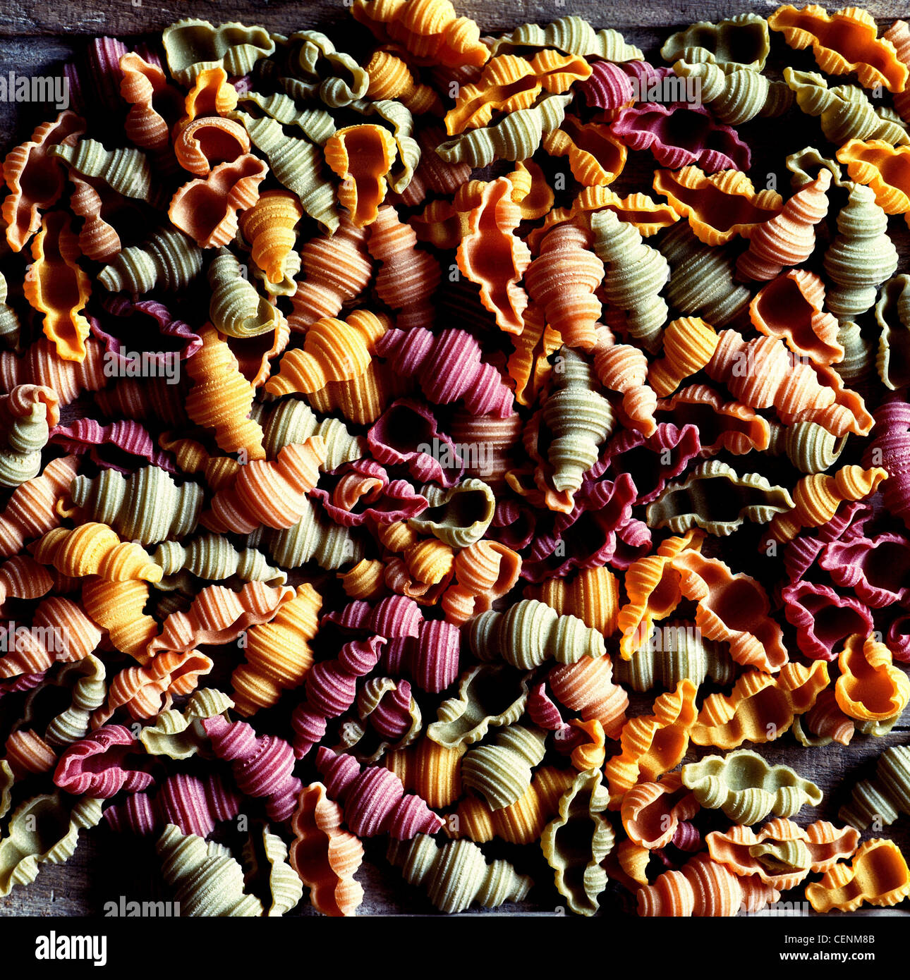 Tricolore shell pasta out of the packet Stock Photo - Alamy