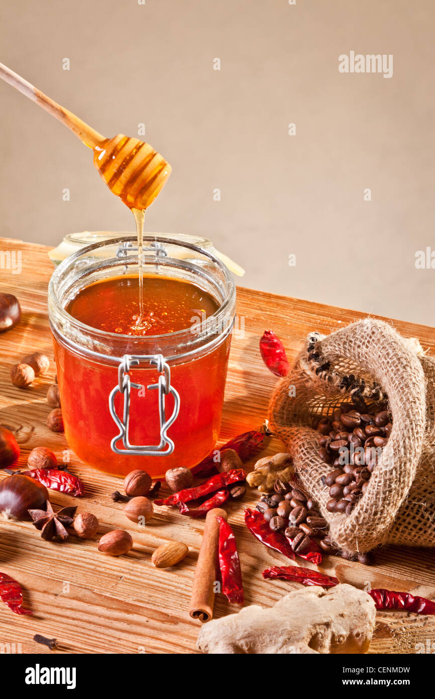 Honey dripping into a jar next to some coffee beans Stock Photo - Alamy