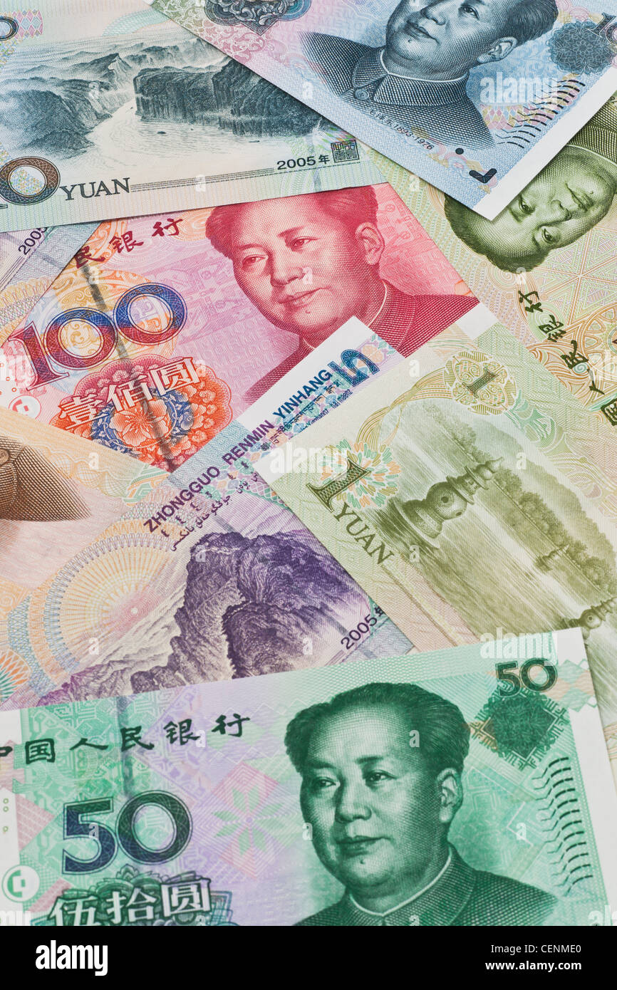 Many Yuan bills with the portrait of Mao Zedong lying side by side. The ...