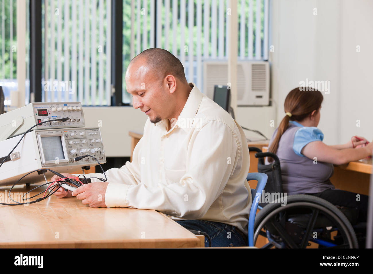 Hispanic engineering student inspecting circuit hi-res stock ...