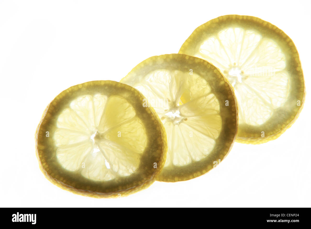 3 slices of lemon on a white backdrop Stock Photo - Alamy