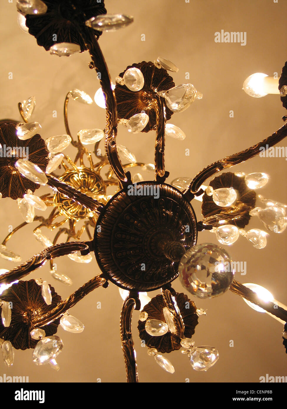 Ceiling hanging light fitting with decorative gold arms and crystal ...