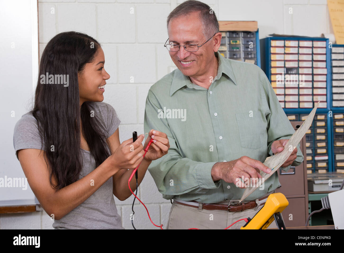 Engineering professor showing a resistor value chart to a student Stock ...