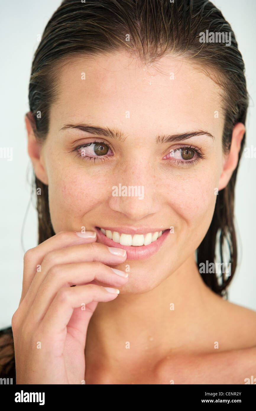 Female long wet brunette hair swept around on to one shoulder looking ...