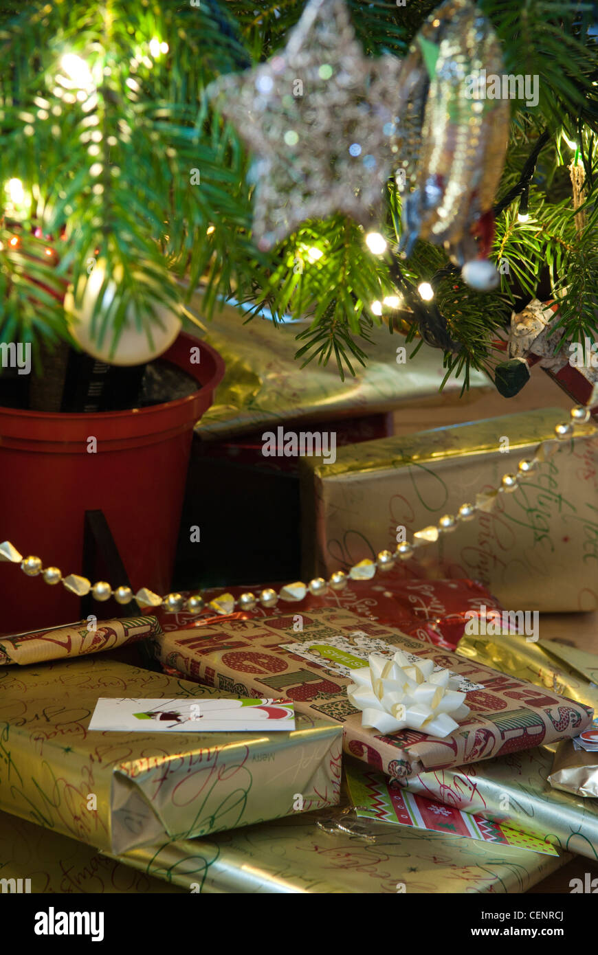 Gift wrapped presents under a real Christmas tree Stock Photo - Alamy