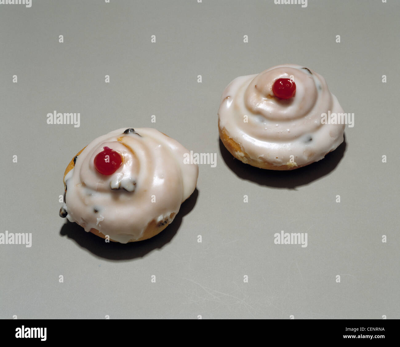 Two cherry buns with a grey background Stock Photo - Alamy