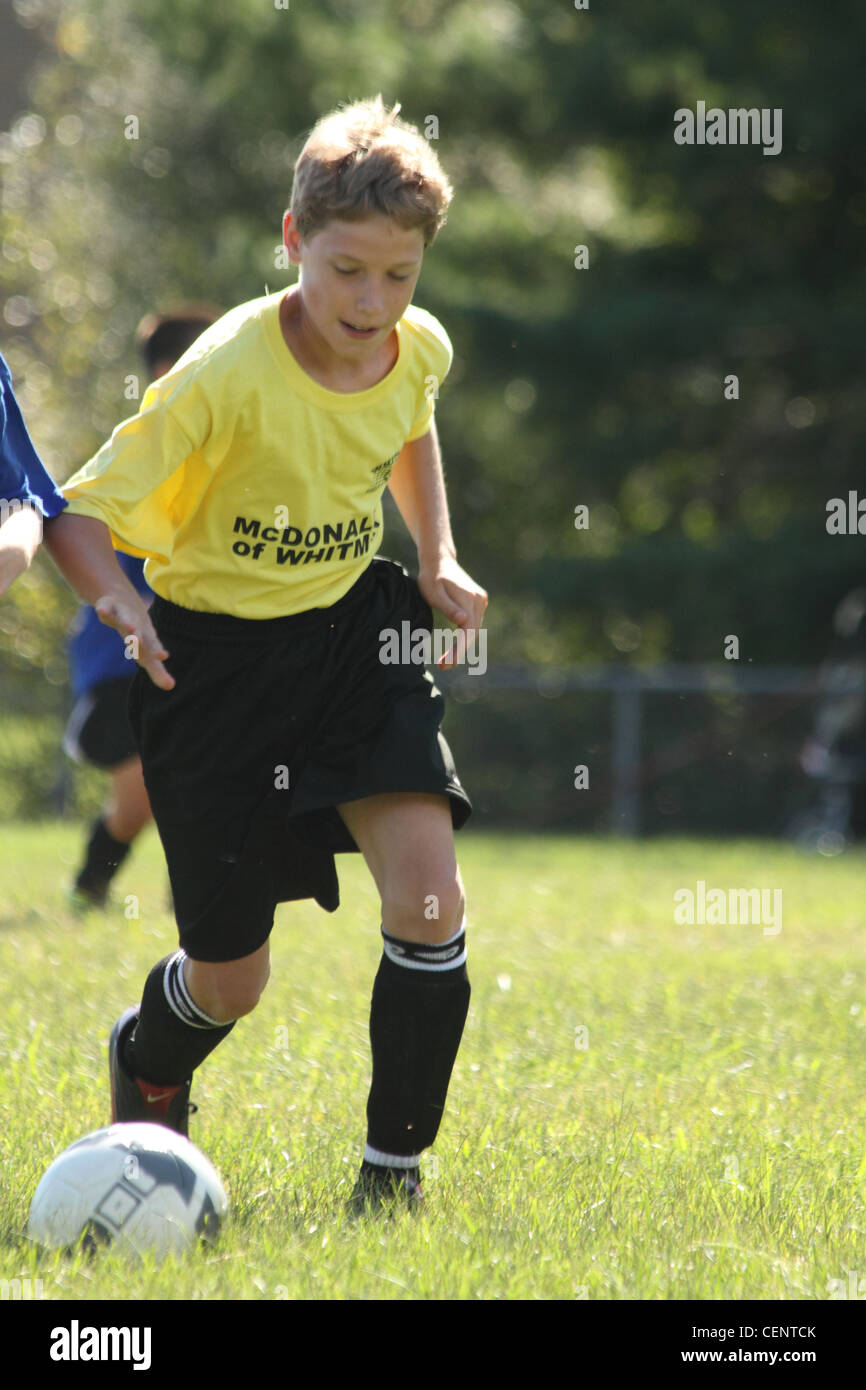 soccer game boy 10-12 years old ball full body action Stock Photo - Alamy