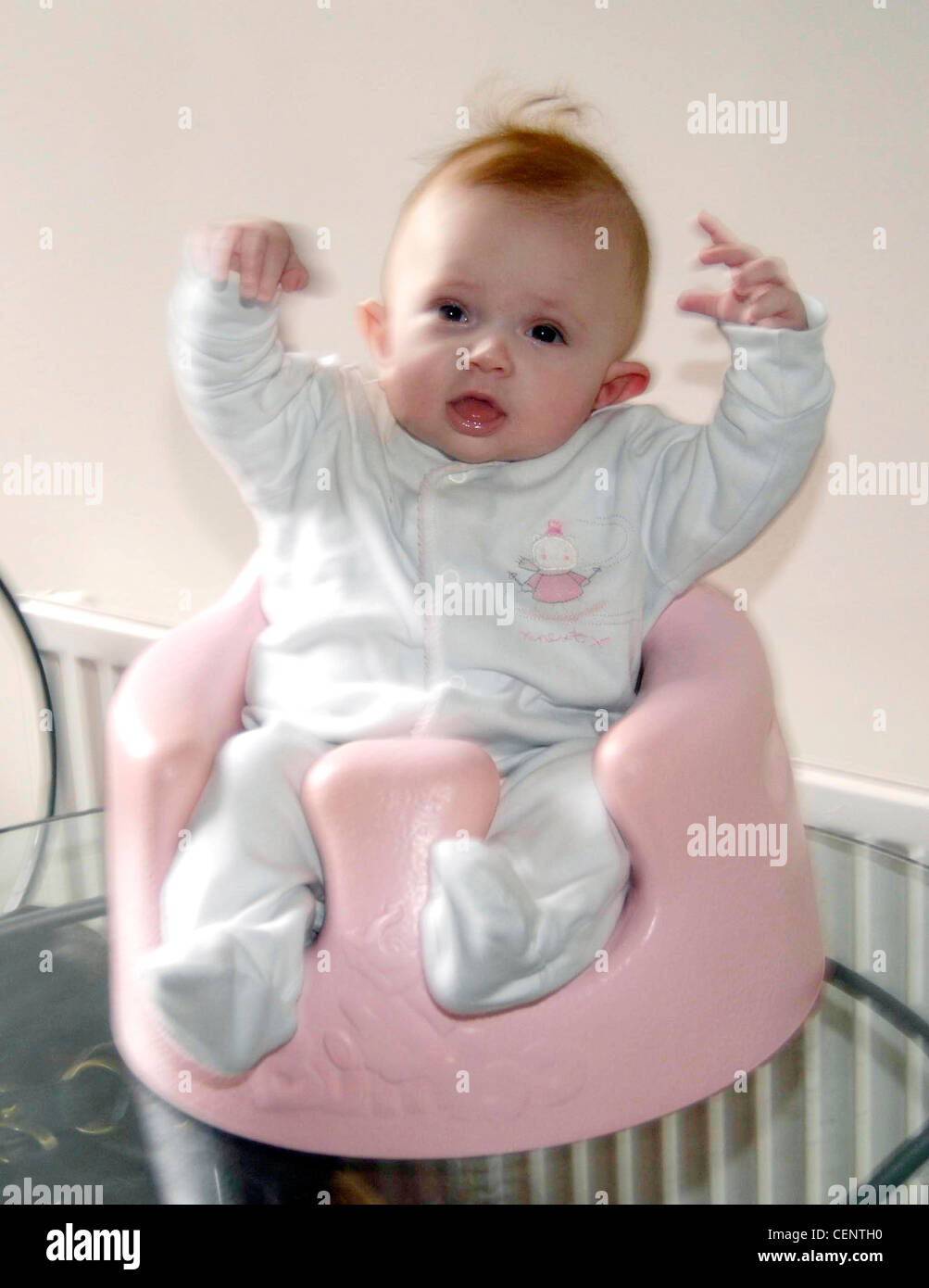 Baby girl in pink babygro hi-res stock photography and images - Alamy