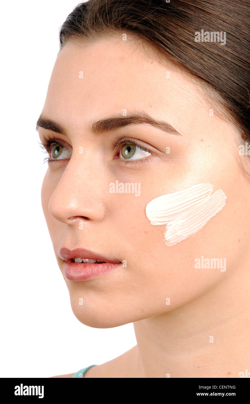 Semi profile of female with brunette hair off face looking up with ...