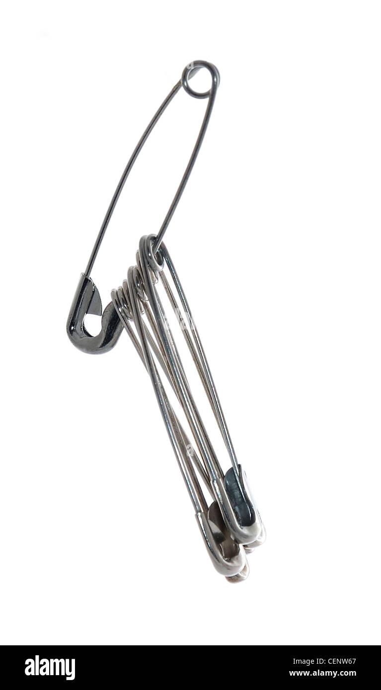 Metal hanged safety pins isolation on white background Stock Photo - Alamy