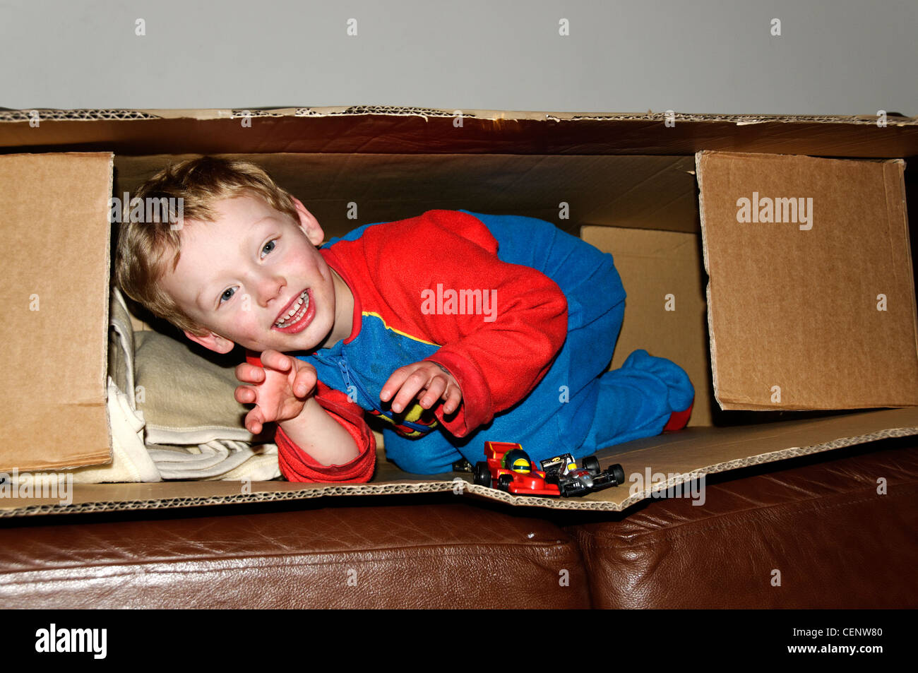 A boy playing in a cardboard box Stock Photo - Alamy