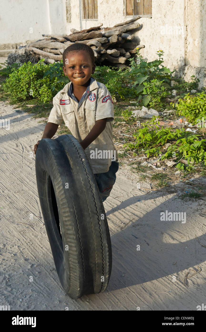 Boy rolling tire hi-res stock photography and images - Alamy