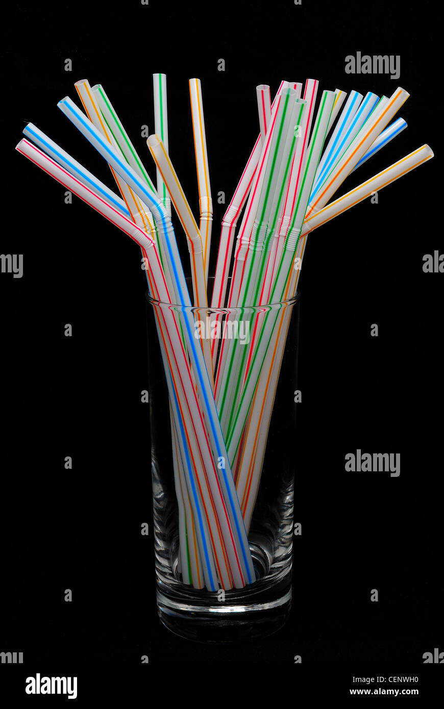 Color straw in glass isolated on the black background Stock Photo - Alamy