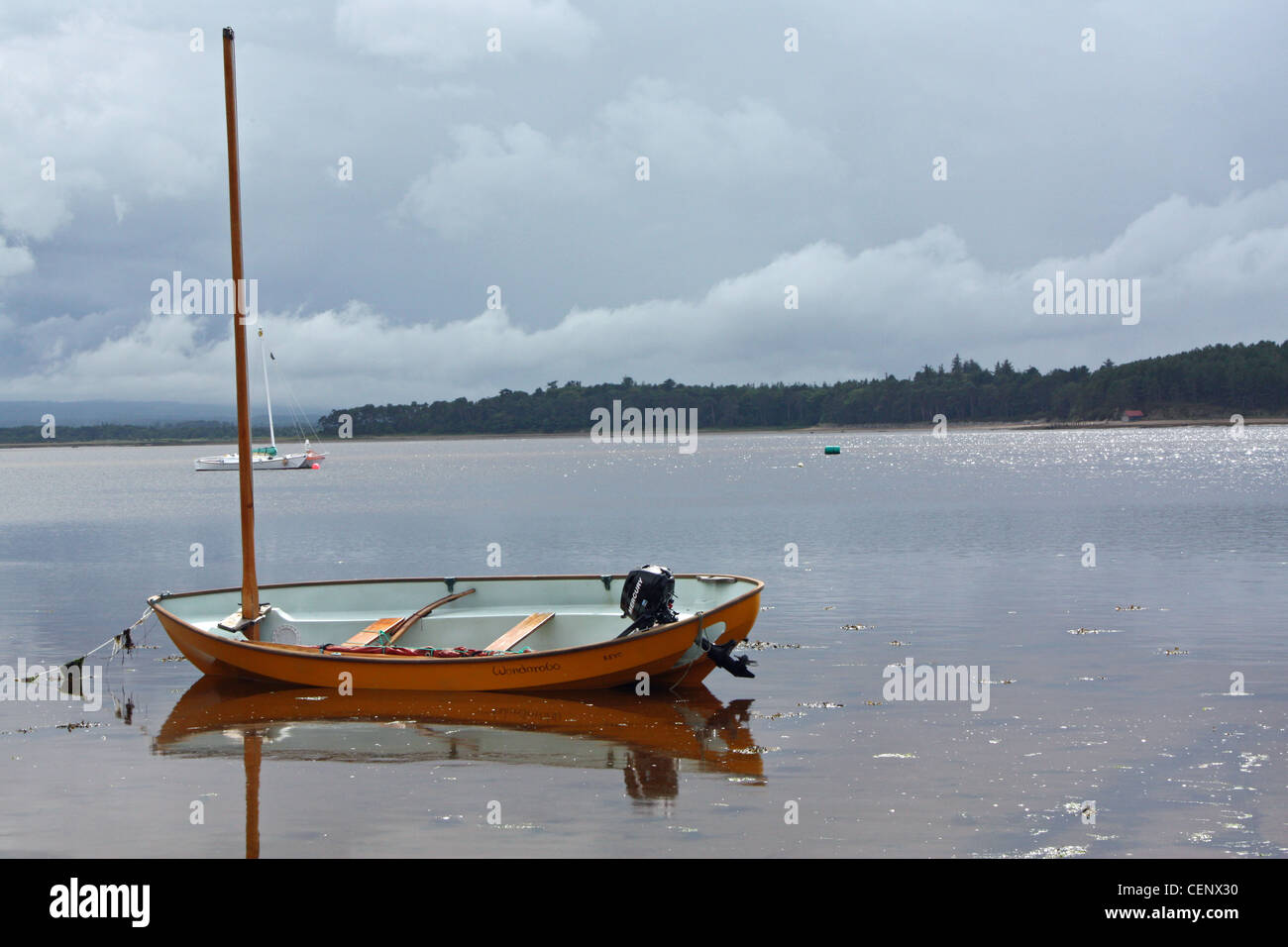 Orange boat in an estuary Stock Photo - Alamy