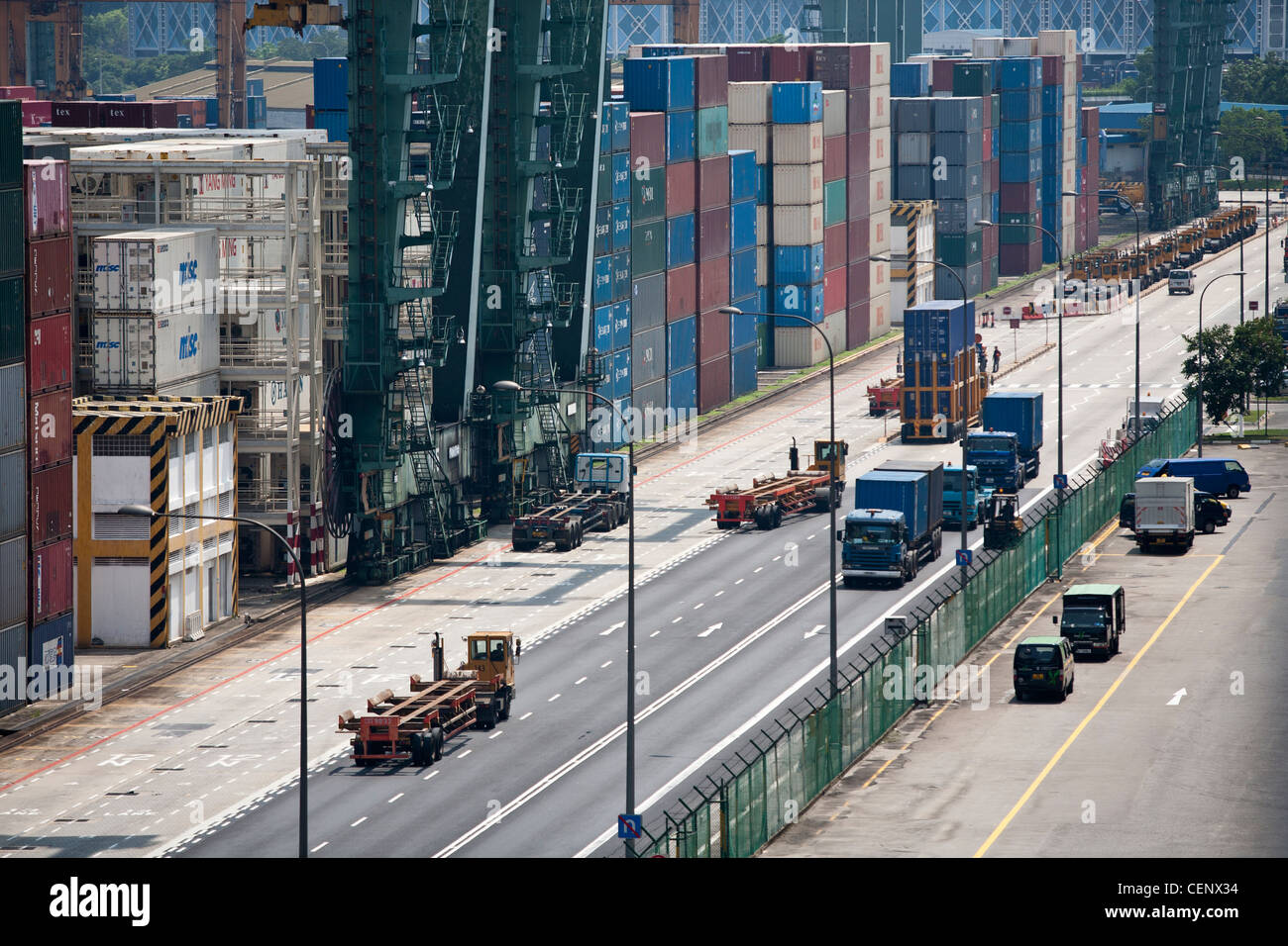 Trucks transport shipping containers at the Port of Singapore Stock ...