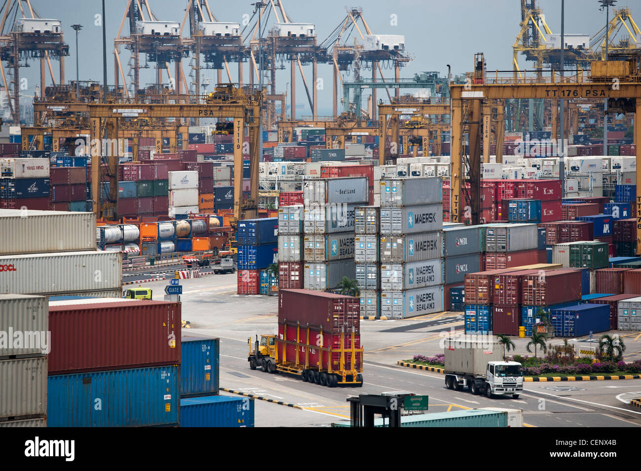 Trucks transport shipping containers at the Port of Singapore Stock ...