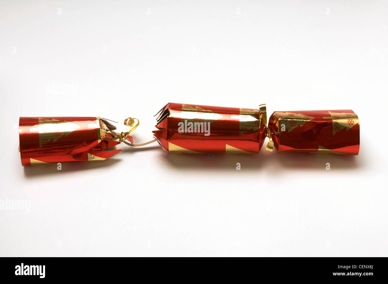 Red Christmas cracker with gold Christmas tree and snowflake design ...