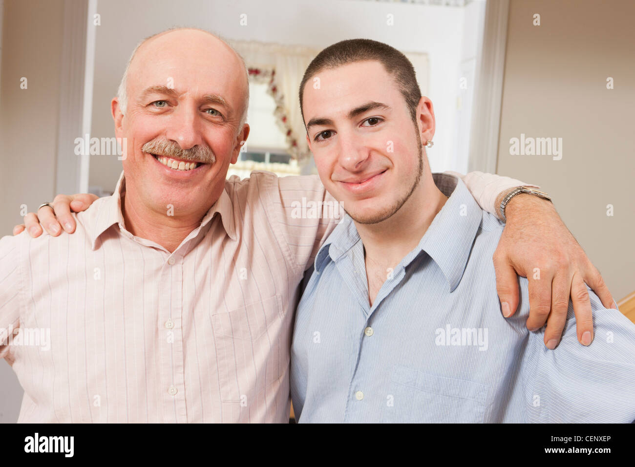 Portrait of father smiling with his son smiling Stock Photo - Alamy