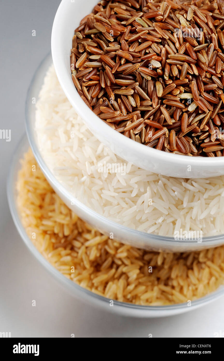 Three stacked bowls of red rice, basmati rice and brown rice Stock ...
