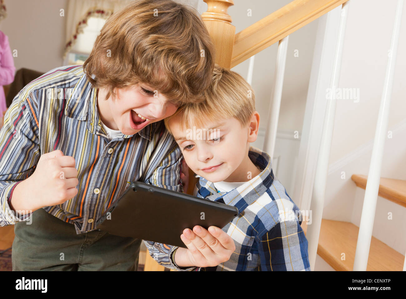 Close-up of two brothers playing on a digital tablet Stock Photo - Alamy